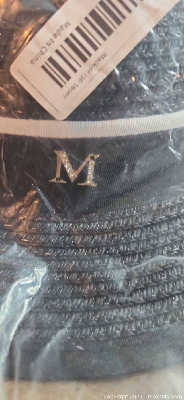 Black straw hat with rhinestone M accent | Maxsold