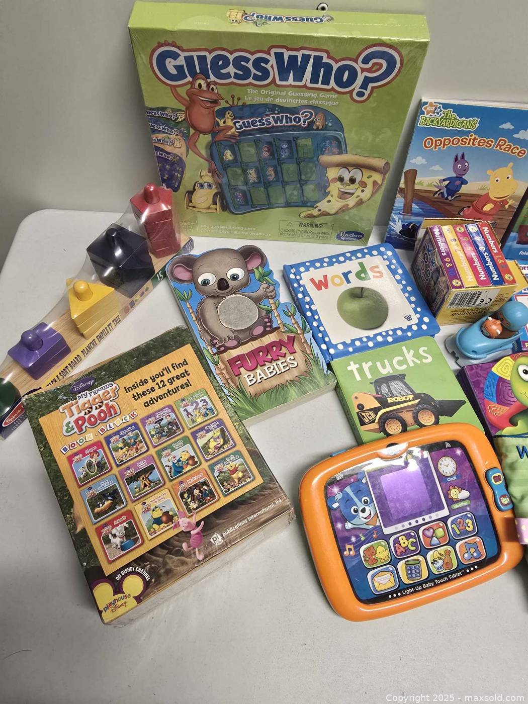 VTech tablet, Guess Who game, board books, Elmo sound book, Disney DVD ...