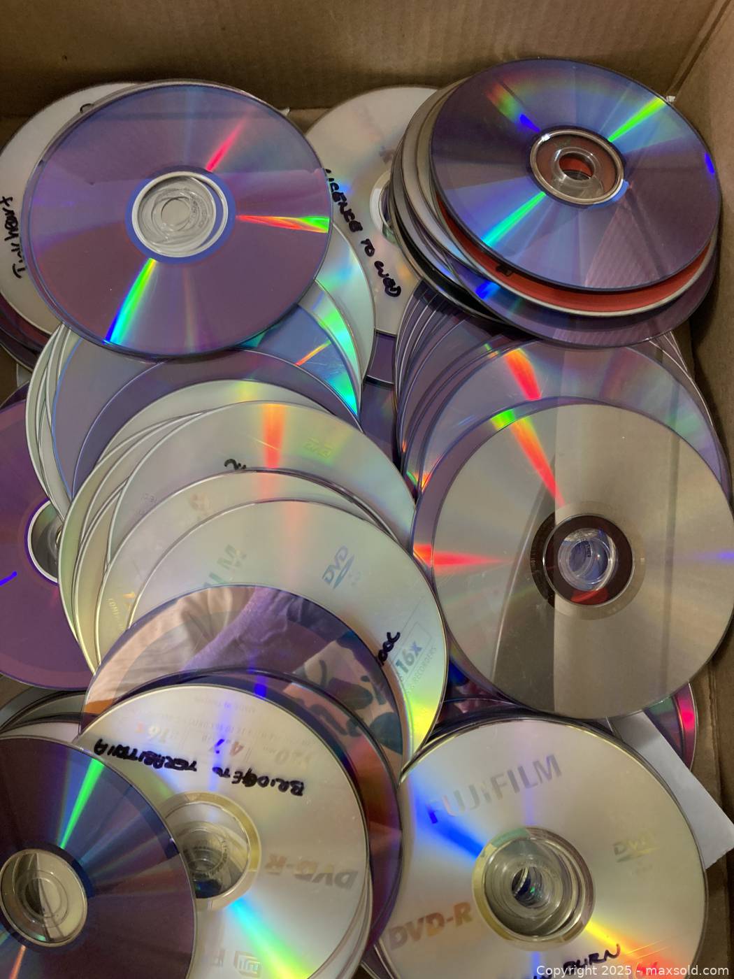 Box of used recordable CDs and DVDs | Maxsold