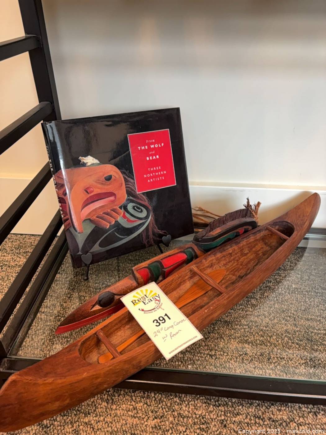 Carved 24" wooden canoe & Indigenous art book | Maxsold