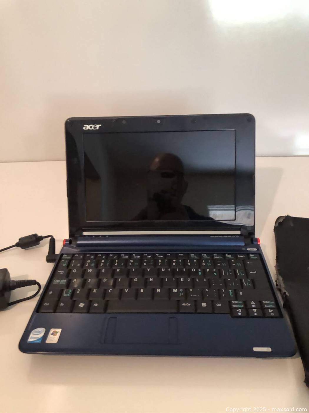 Acer blue netbook with charger and sleeve | Maxsold