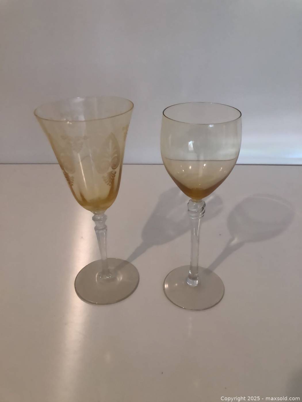 Two antique pale yellow blown wine goblets | Maxsold