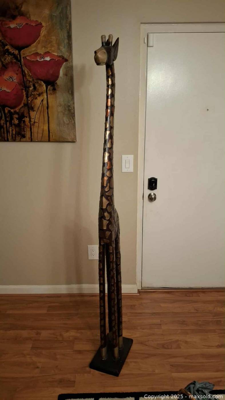 Tall dark brown giraffe statue | Maxsold