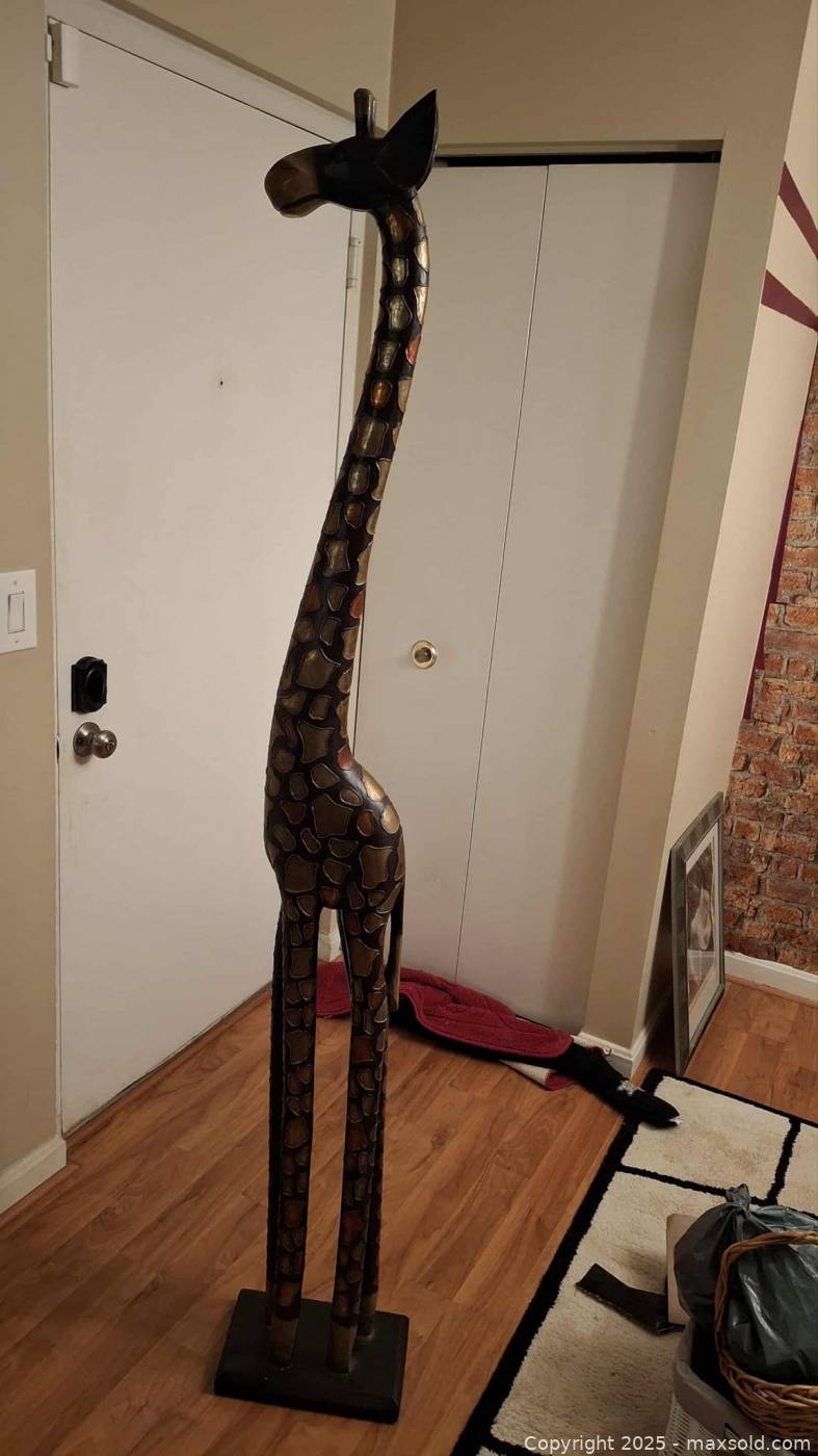 Tall dark brown giraffe statue | Maxsold