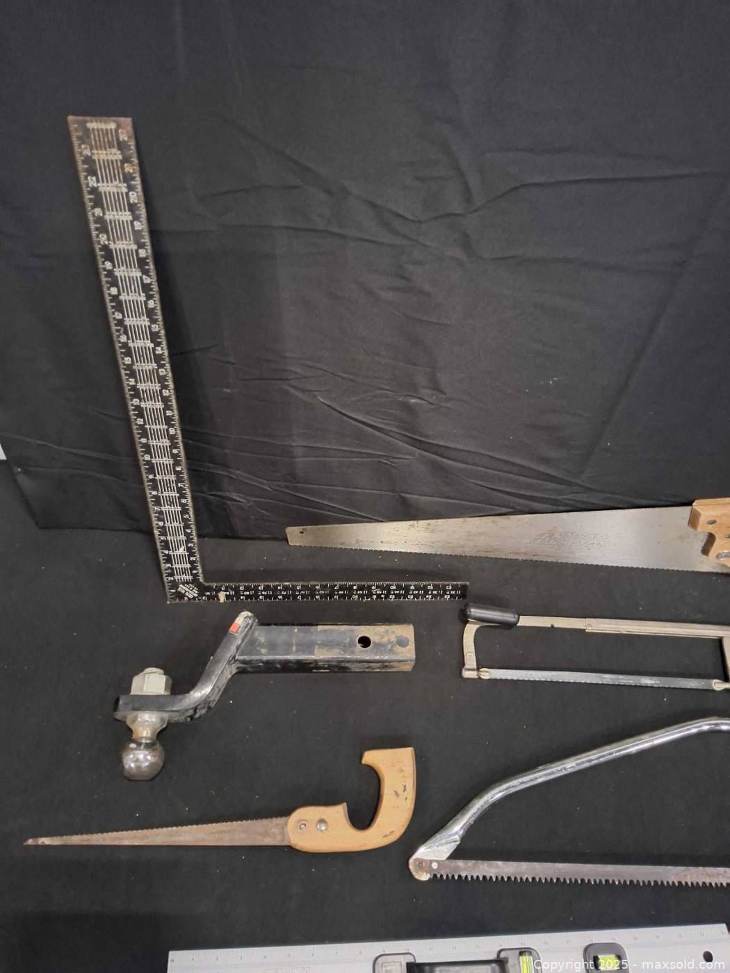 Hand saws, framing square, hitch coupler, tools | Maxsold