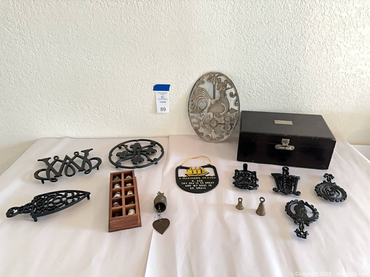 Vintage cast-iron trivets, metal plaques, wood keepsake box, thimble ...