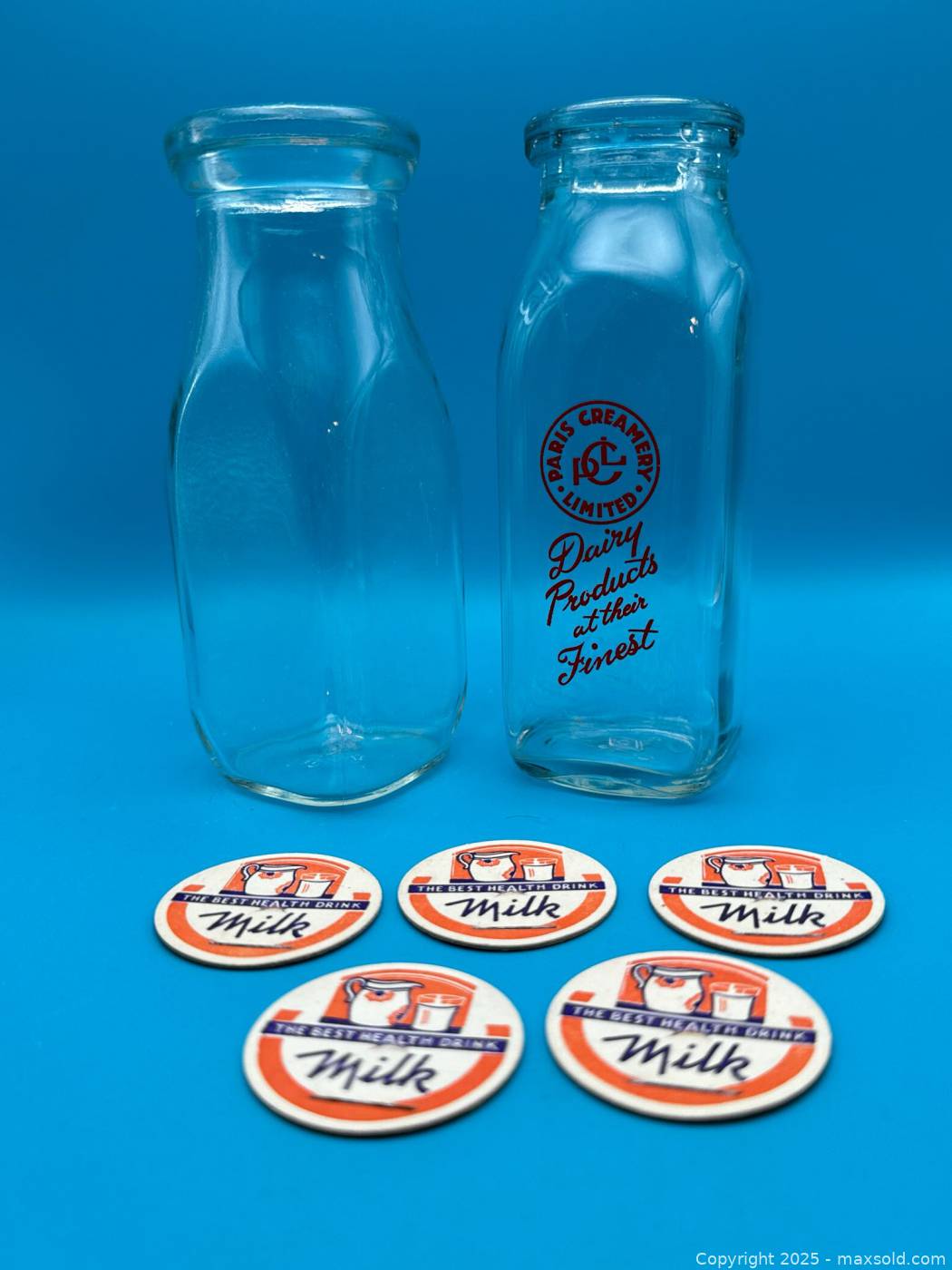 Paris Creamery glass milk bottles with caps | Maxsold
