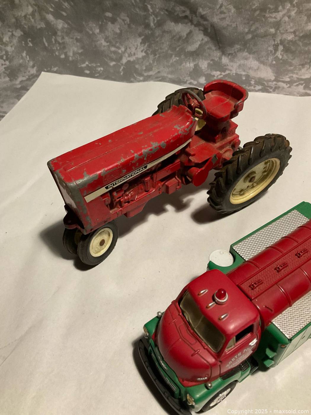 Vintage metal farm tractor and North Pole tanker truck | Maxsold