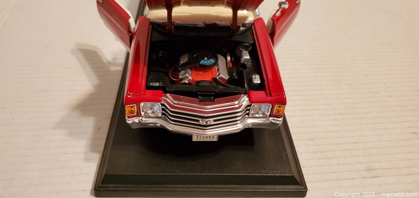 Maisto red and white Chevy Camaro model car on display stand | Maxsold