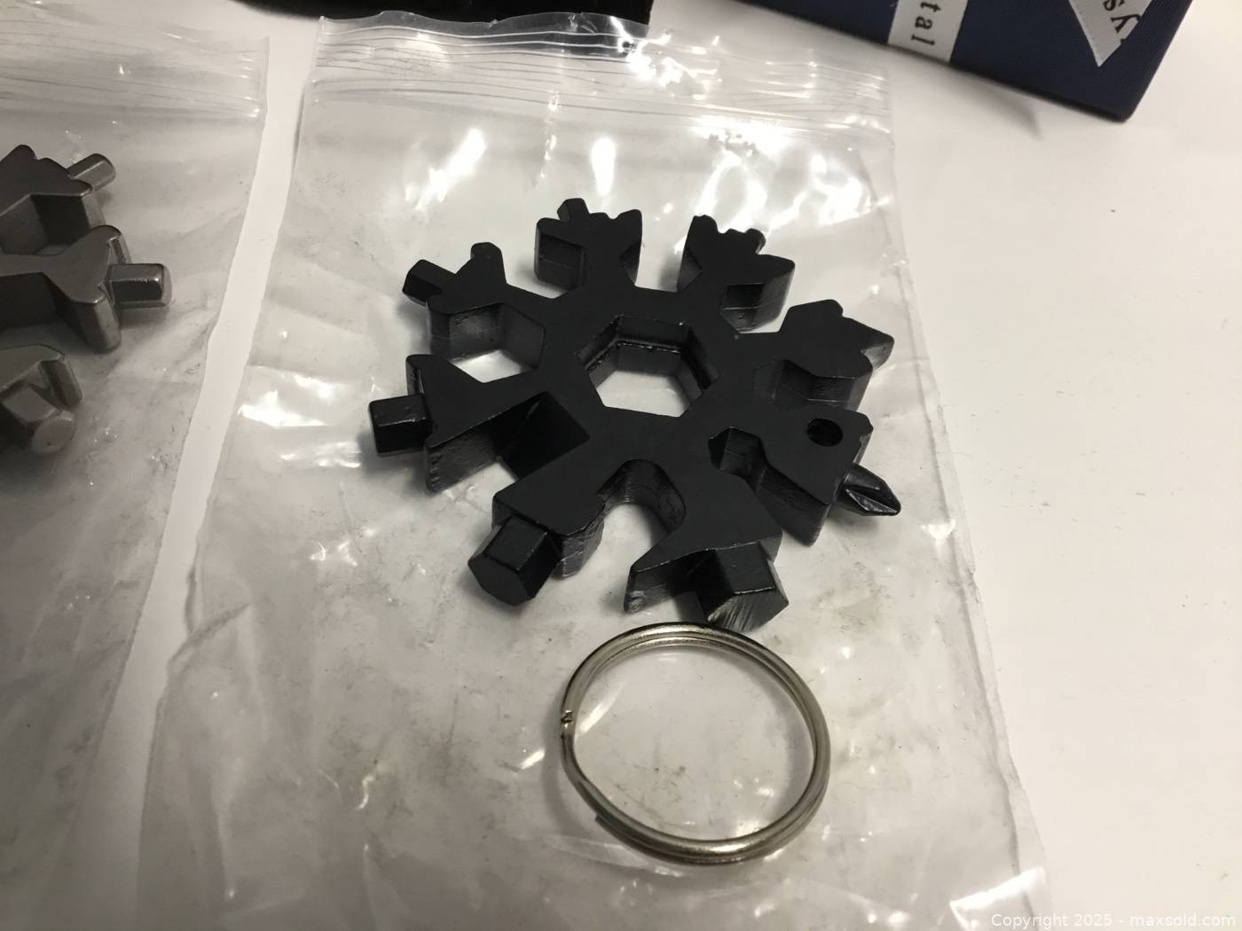 Pair 18-in-1 snowflake multi-tool keychains | Maxsold