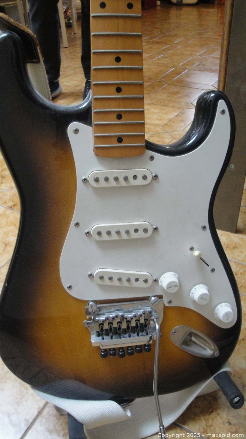 Phoenix Strat-style electric guitar with stand | Maxsold