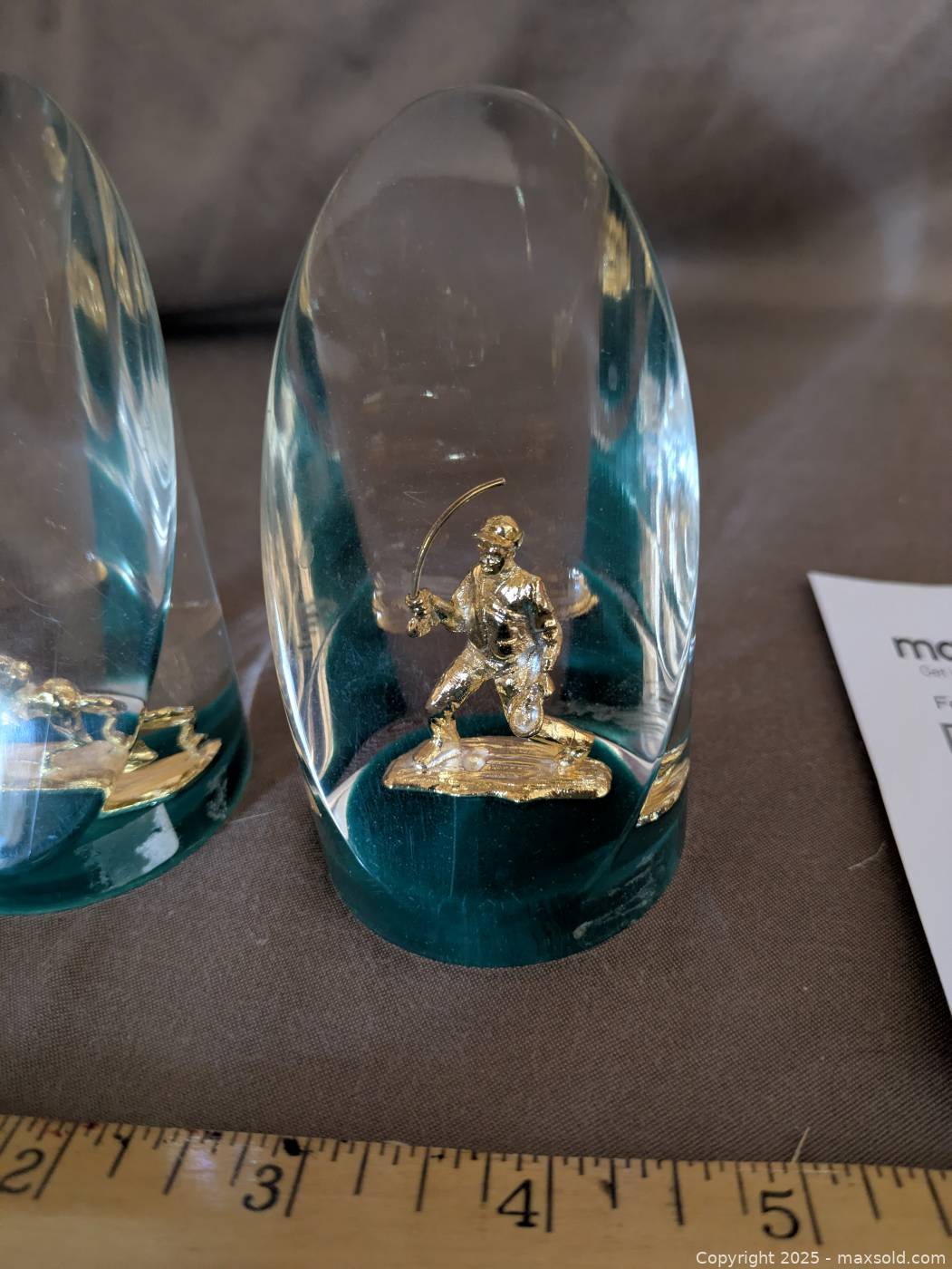 Two acrylic dome paperweights with gold-tone figurines | Maxsold