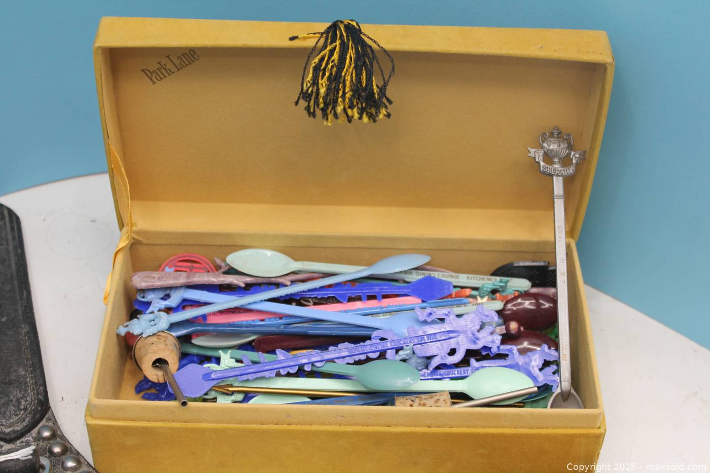 Box of swizzle sticks, copper candle holder, folding yardstick, lock ...