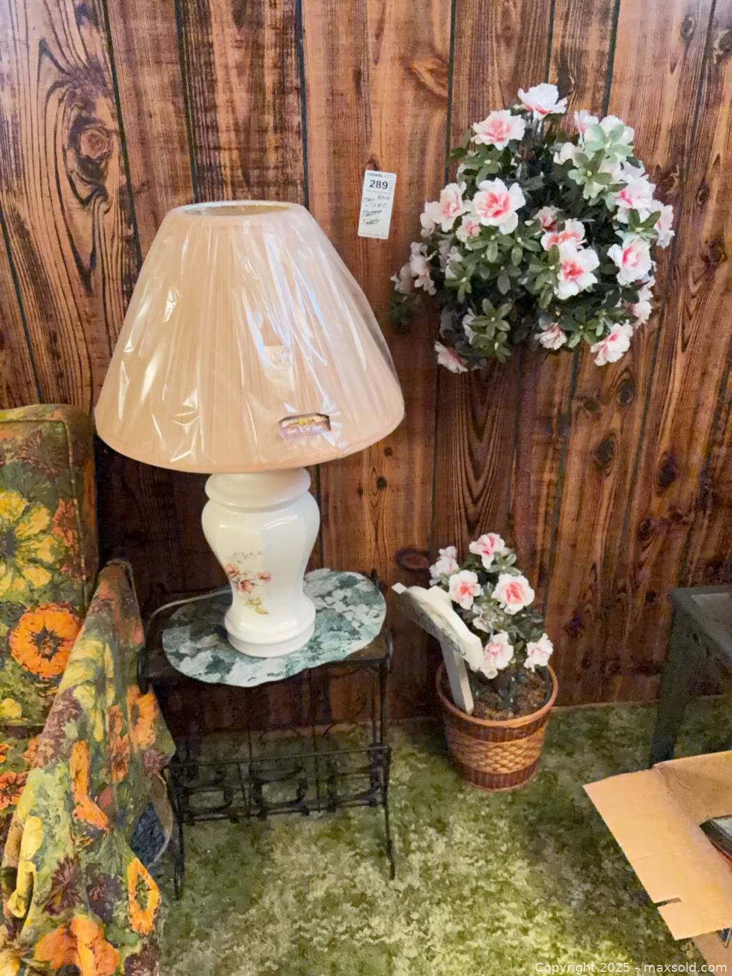 Wrought-iron magazine rack side table & faux floral topiary | Maxsold