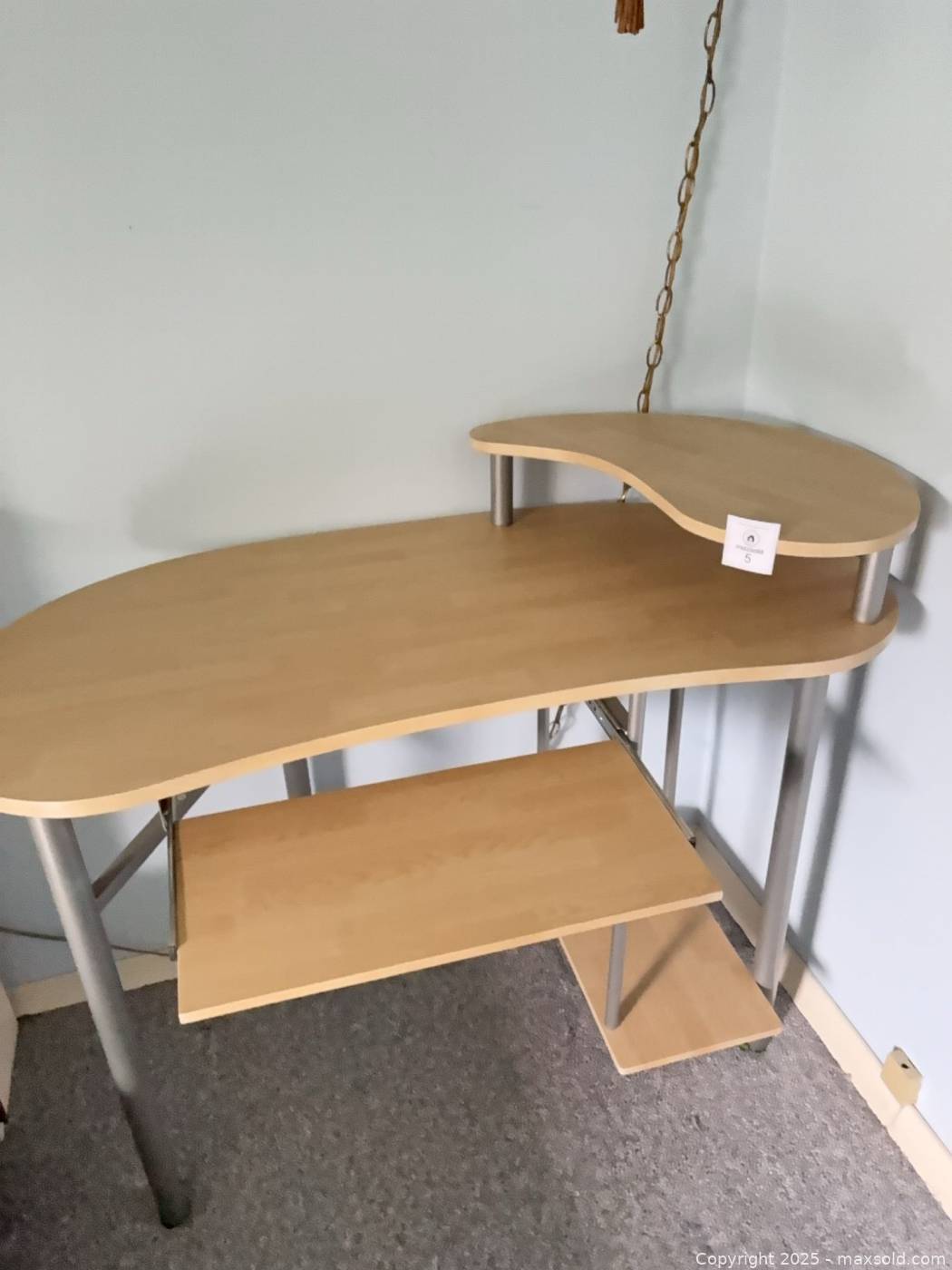 Light wood desk and grey swivel office chair | Maxsold