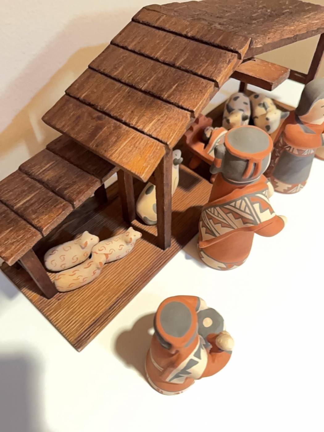 Indigenous hand-crafted clay nativity with wood stable | Maxsold