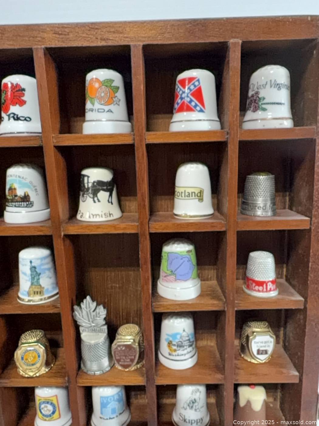 Wooden display case with 60 souvenir thimbles | Maxsold