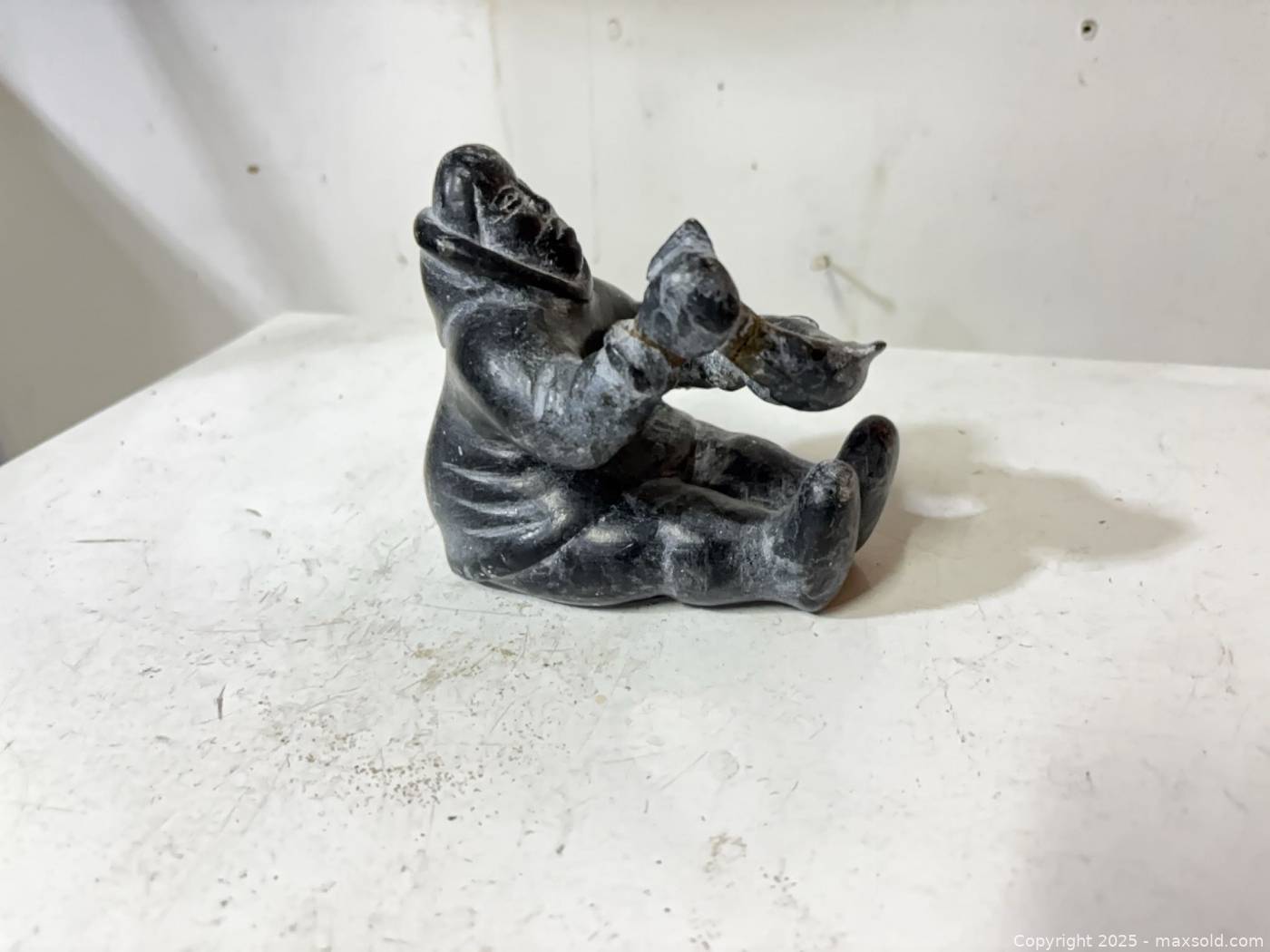 Inuit soapstone carving seated figure 4 in | Maxsold