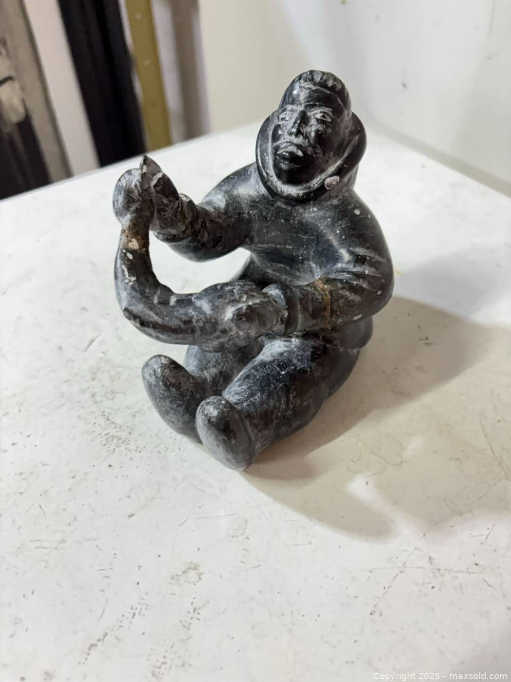 Inuit soapstone carving seated figure 4 in | Maxsold