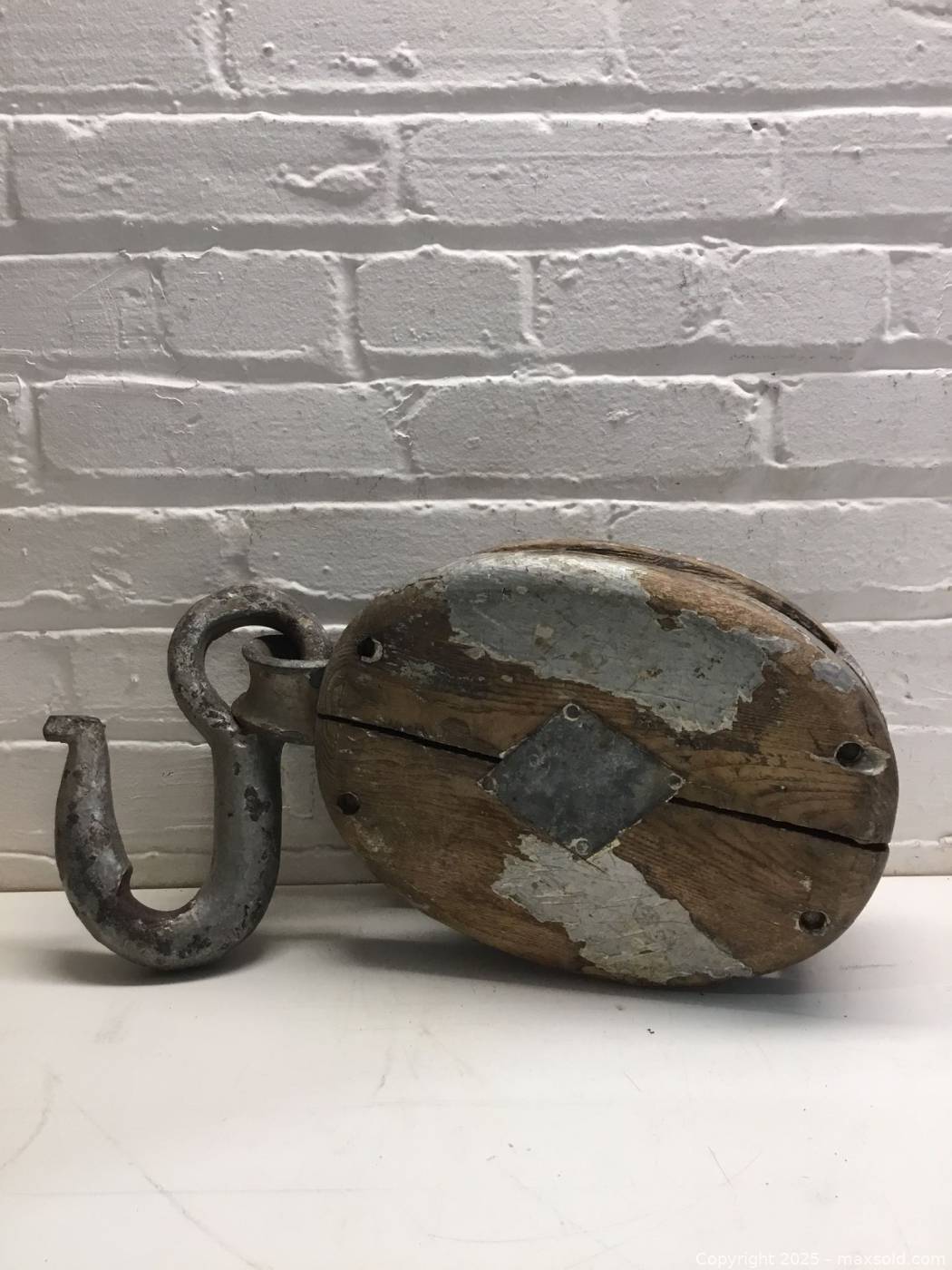 Large antique wooden pulley with iron hook | Maxsold