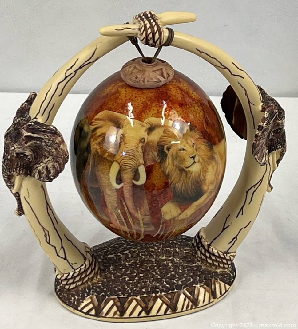 Decorative ostrich egg with wildlife design and tusk stand | Maxsold