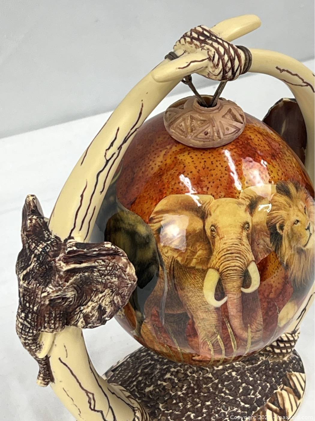Decorative ostrich egg with wildlife design and tusk stand | Maxsold