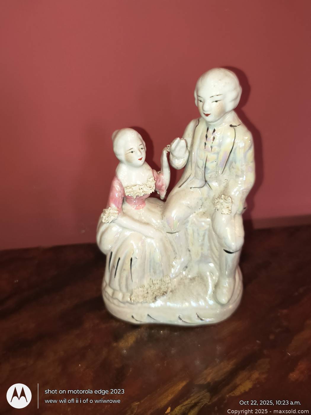 Ceramic figurine of seated couple | Maxsold