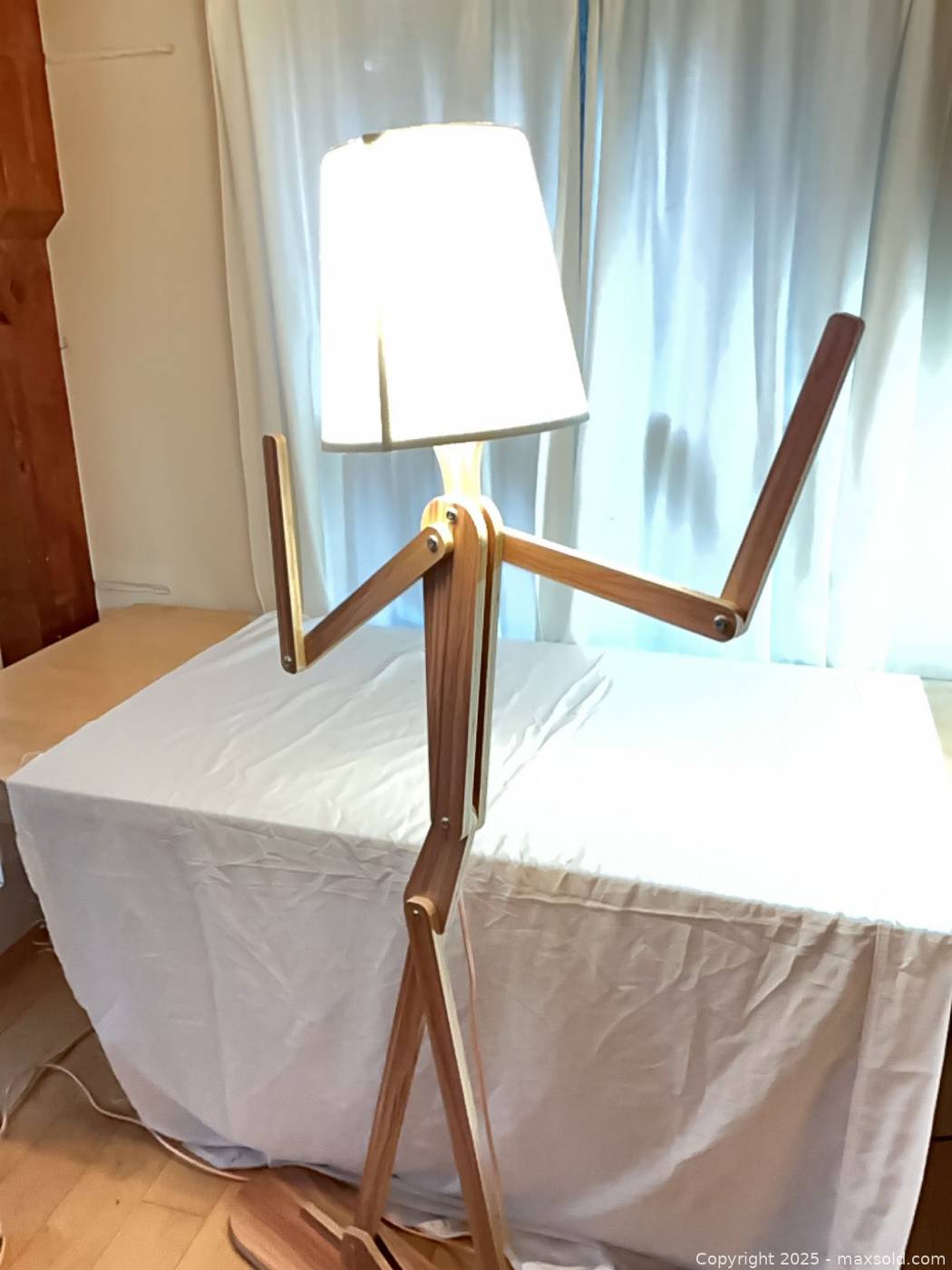 Articulated wood human-form floor lamp | Maxsold