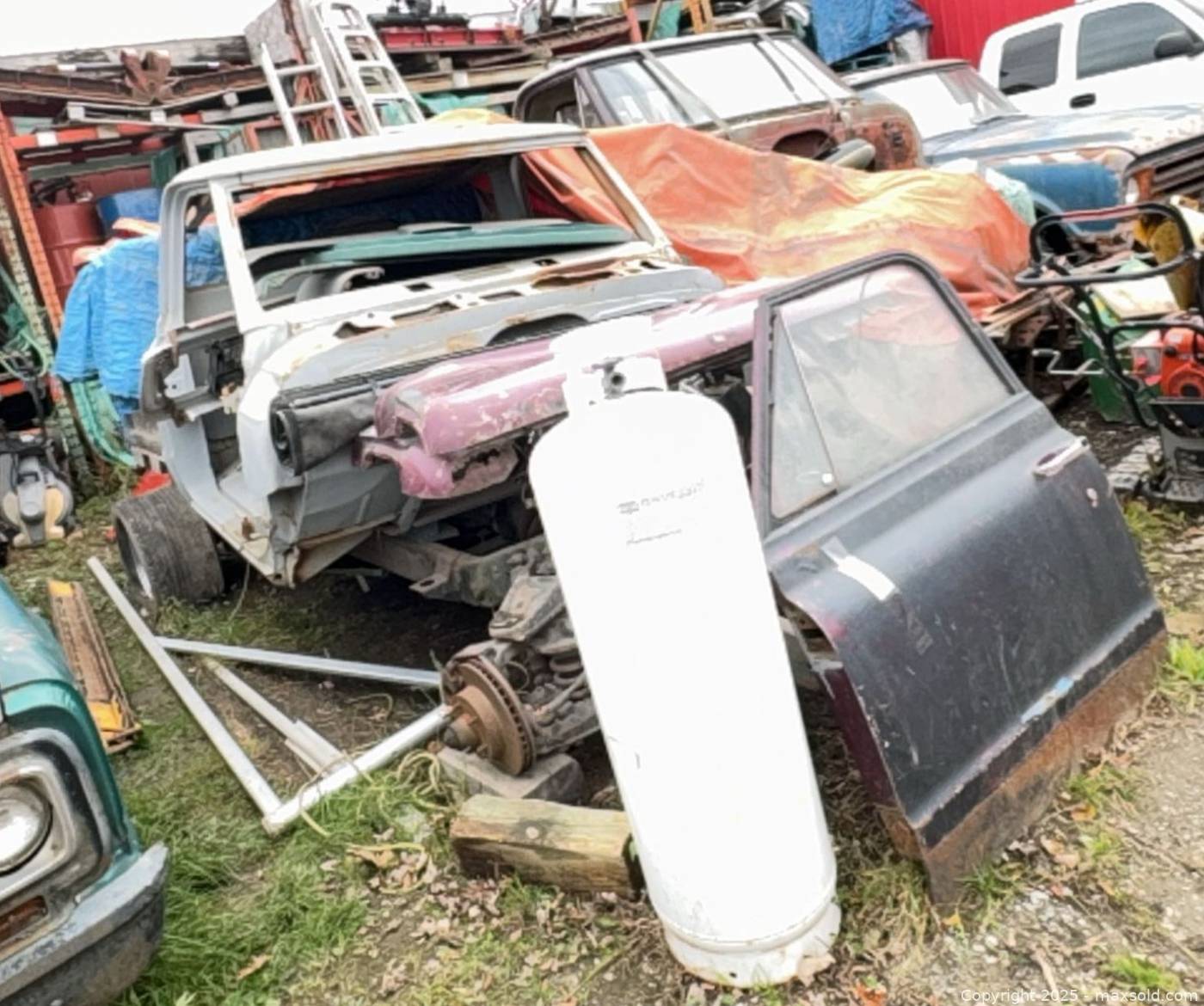 Stripped pickup truck body, door, propane tank, scrap metal | Maxsold