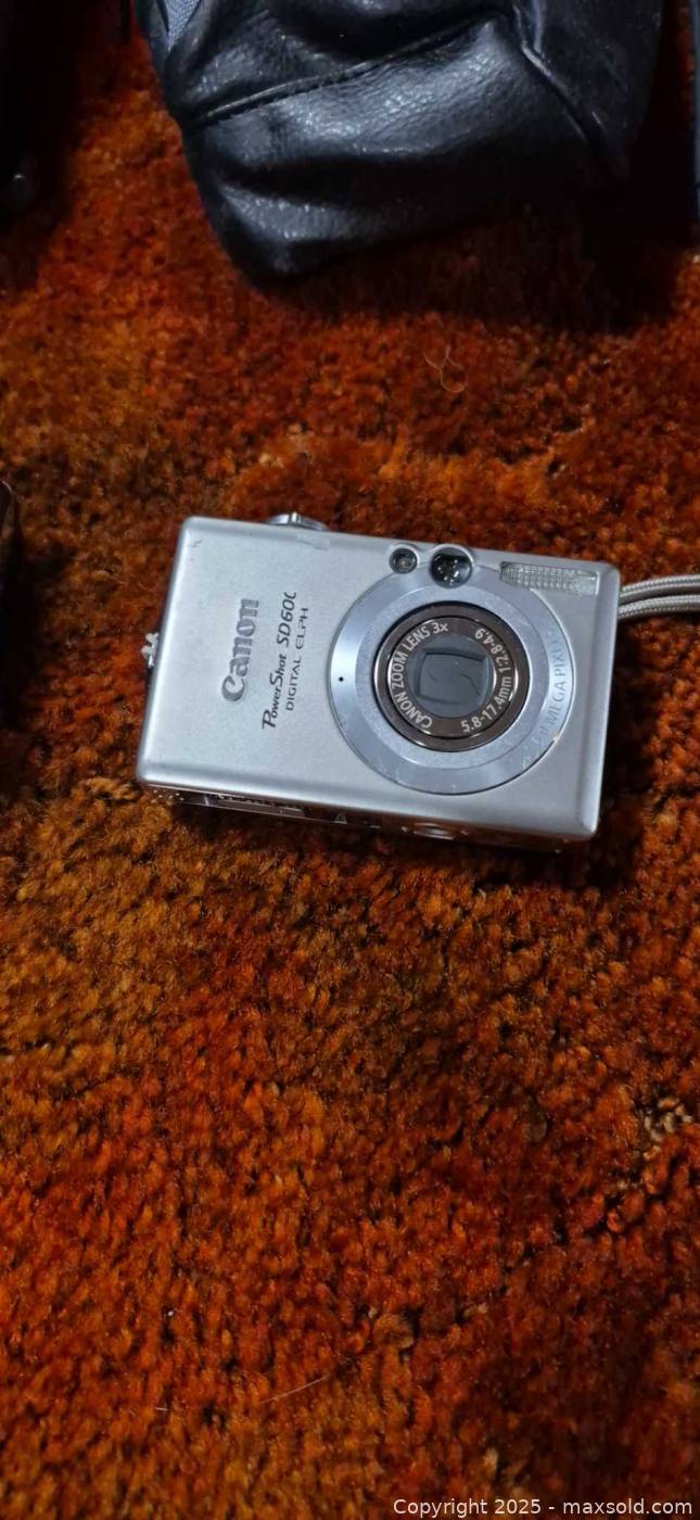 3 Compact Digital Cameras With Accessories | Maxsold