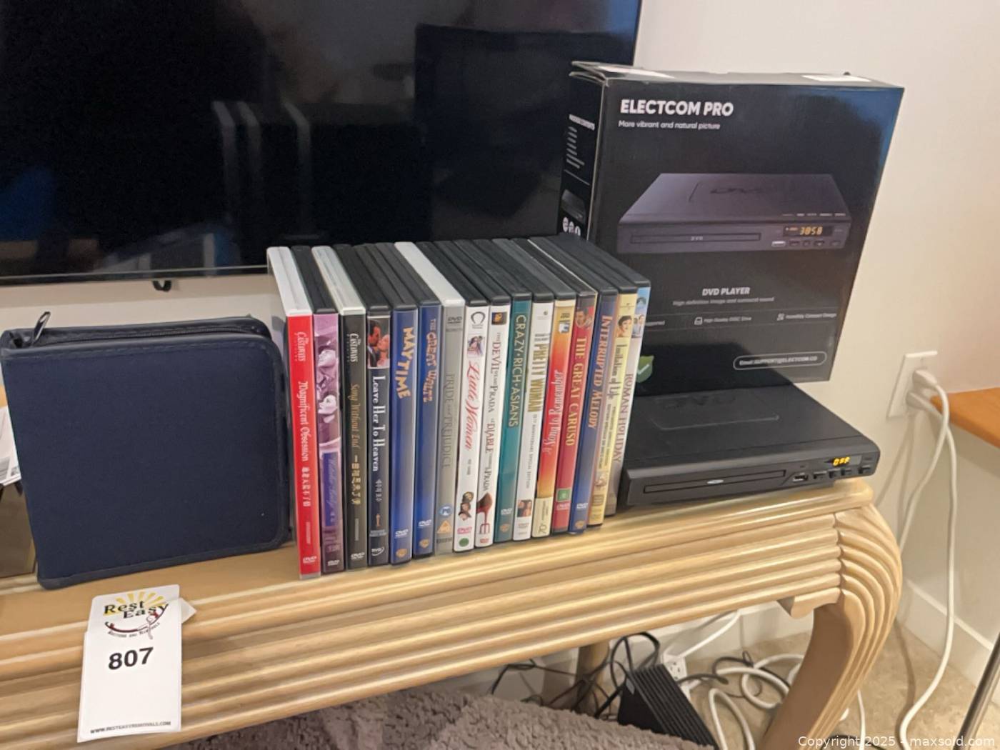 Electcom Pro DVD player with remote and 15 DVDs | Maxsold