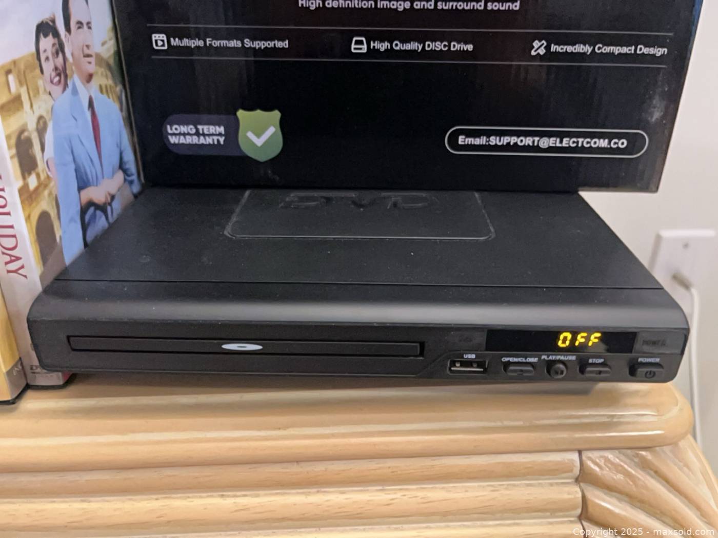 Electcom Pro DVD player with remote and 15 DVDs | Maxsold