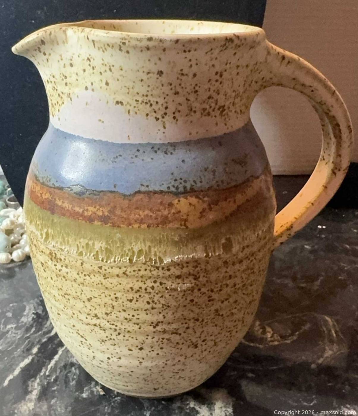 Speckled cream glazed stoneware pitcher | Maxsold