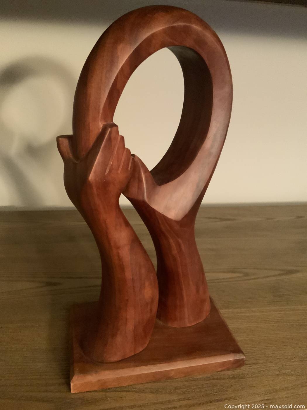 Hand-carved wooden hand sculpture | Maxsold