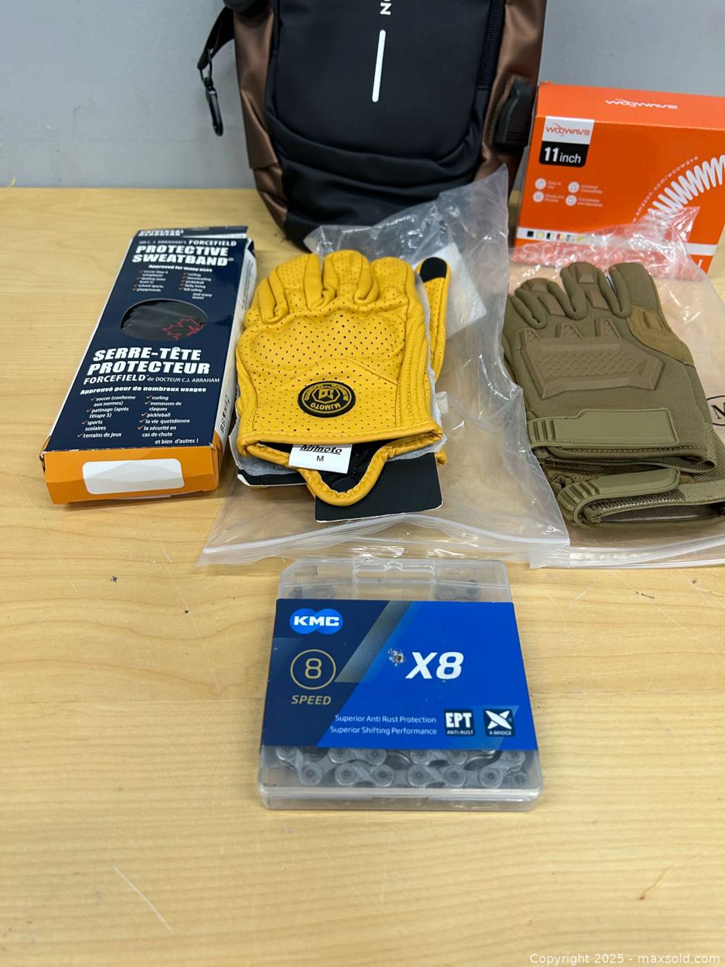 New sling bag, bike chain, 2 pairs medium moto gloves, 11ft surf leash, sweatband | Maxsold