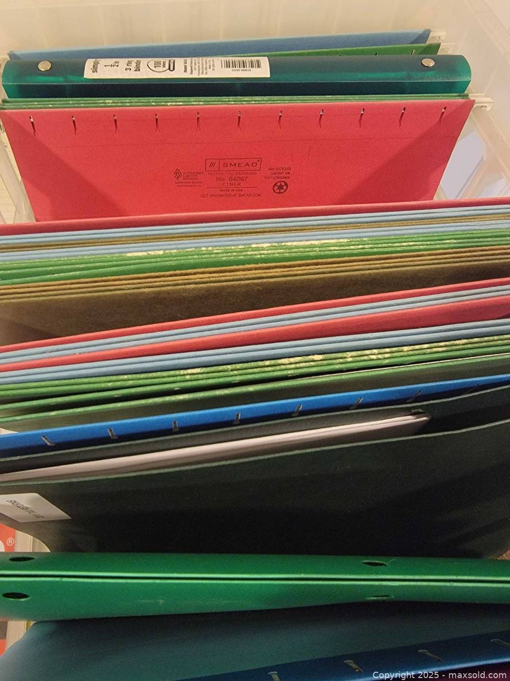 Plastic file crate with hanging file folders, spiral notebooks and ...