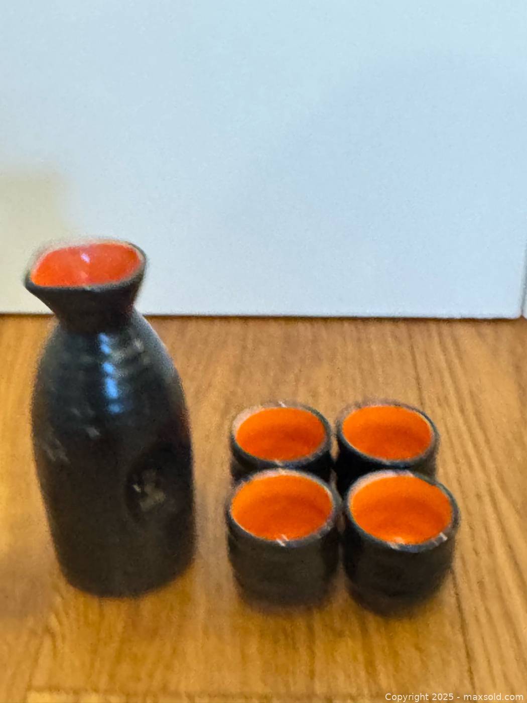 TOUGEI matte black and orange ceramic sake set | Maxsold