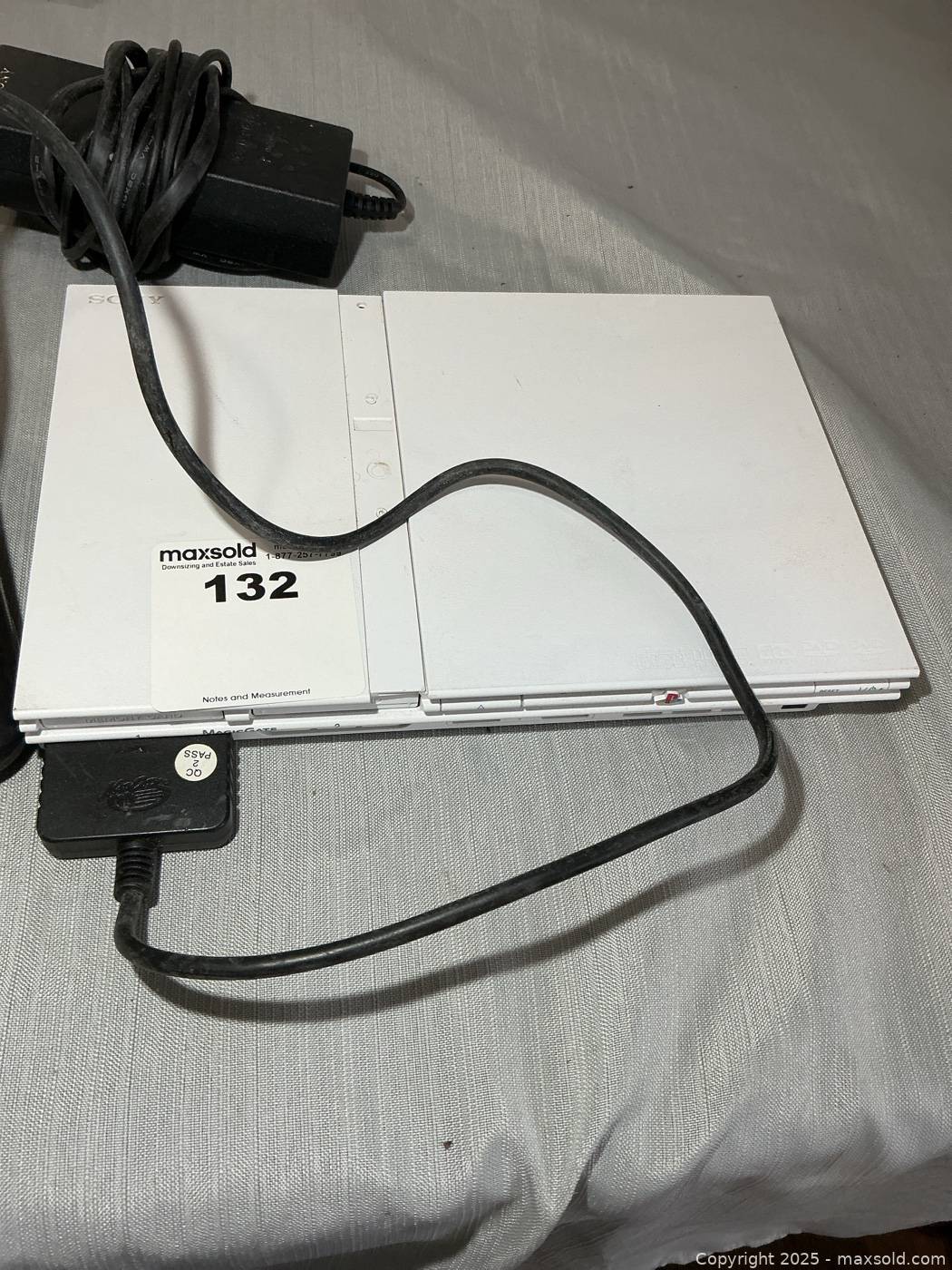 Sony PlayStation 2 Slim console with power adapter and controller | Maxsold