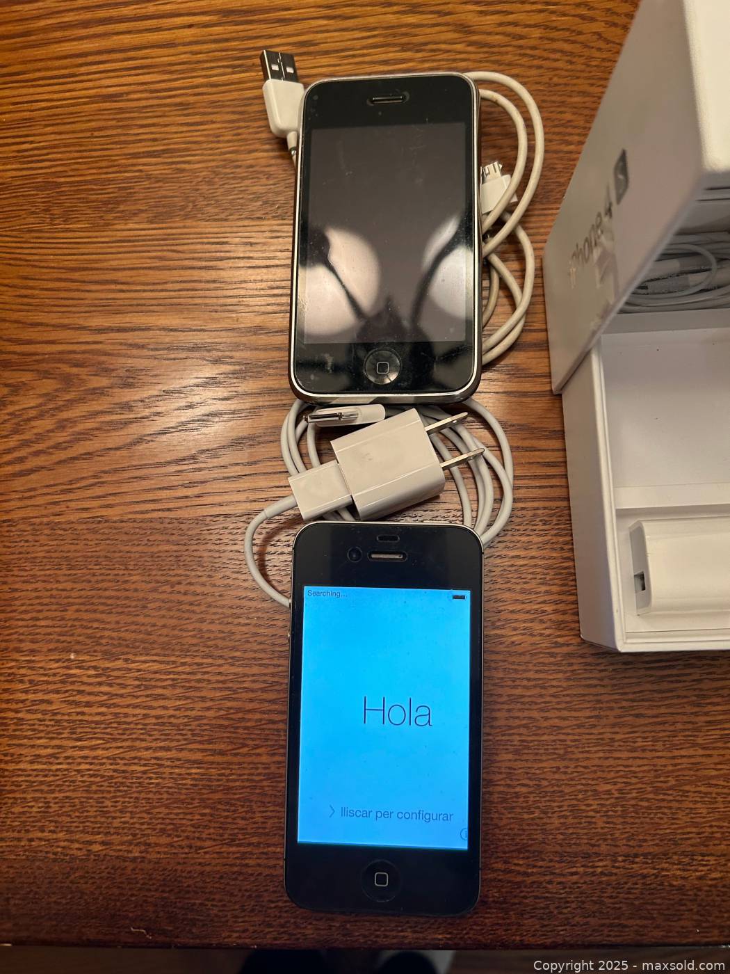 Apple AV adapter, two iPhones, five iPhone boxes | Maxsold