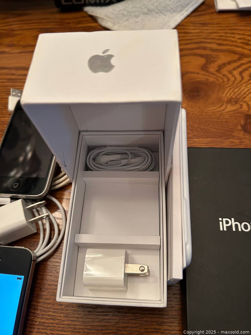 Apple AV adapter, two iPhones, five iPhone boxes | Maxsold
