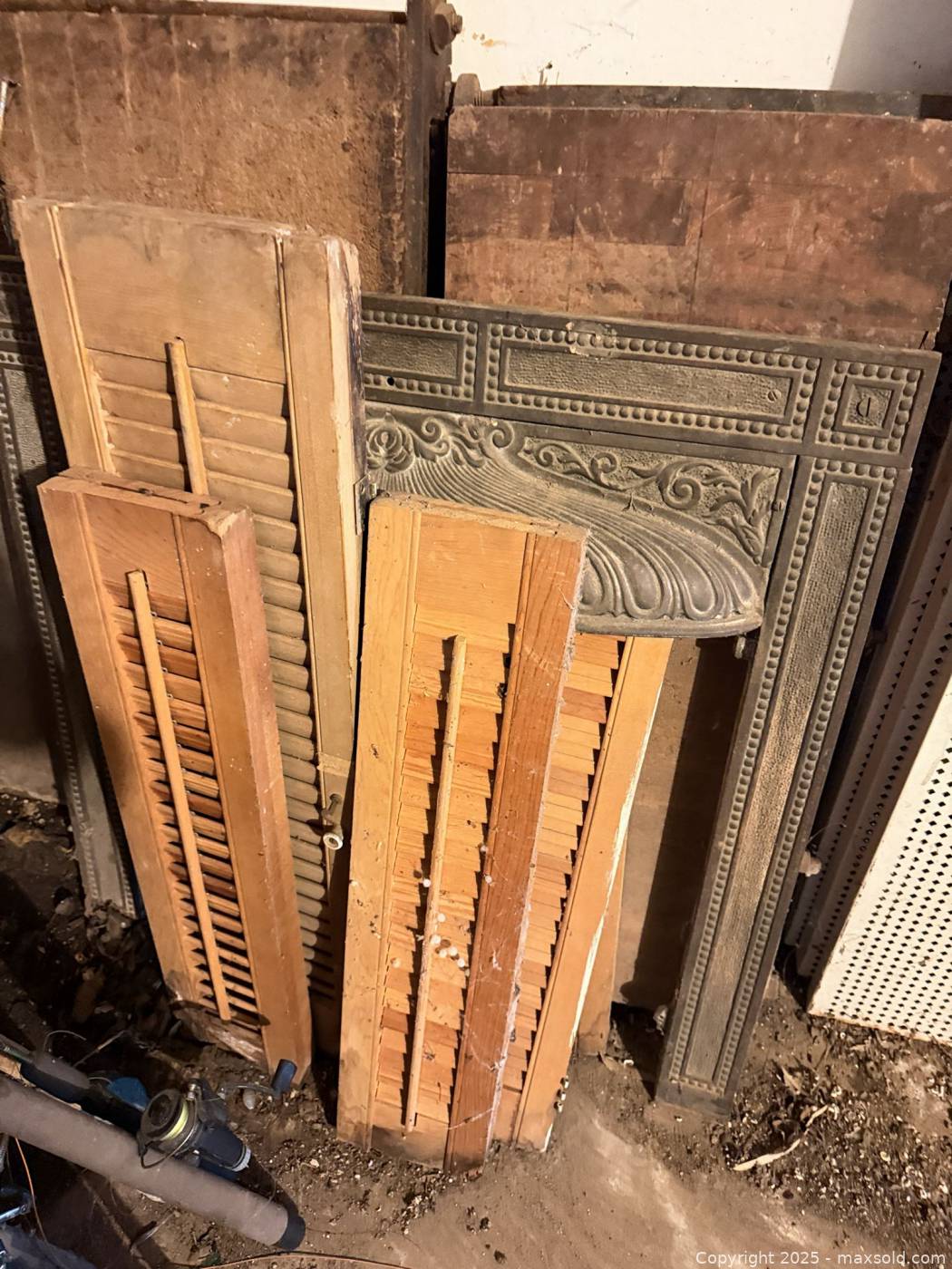 Cast iron fireplace surround with wooden louver and backing panels ...