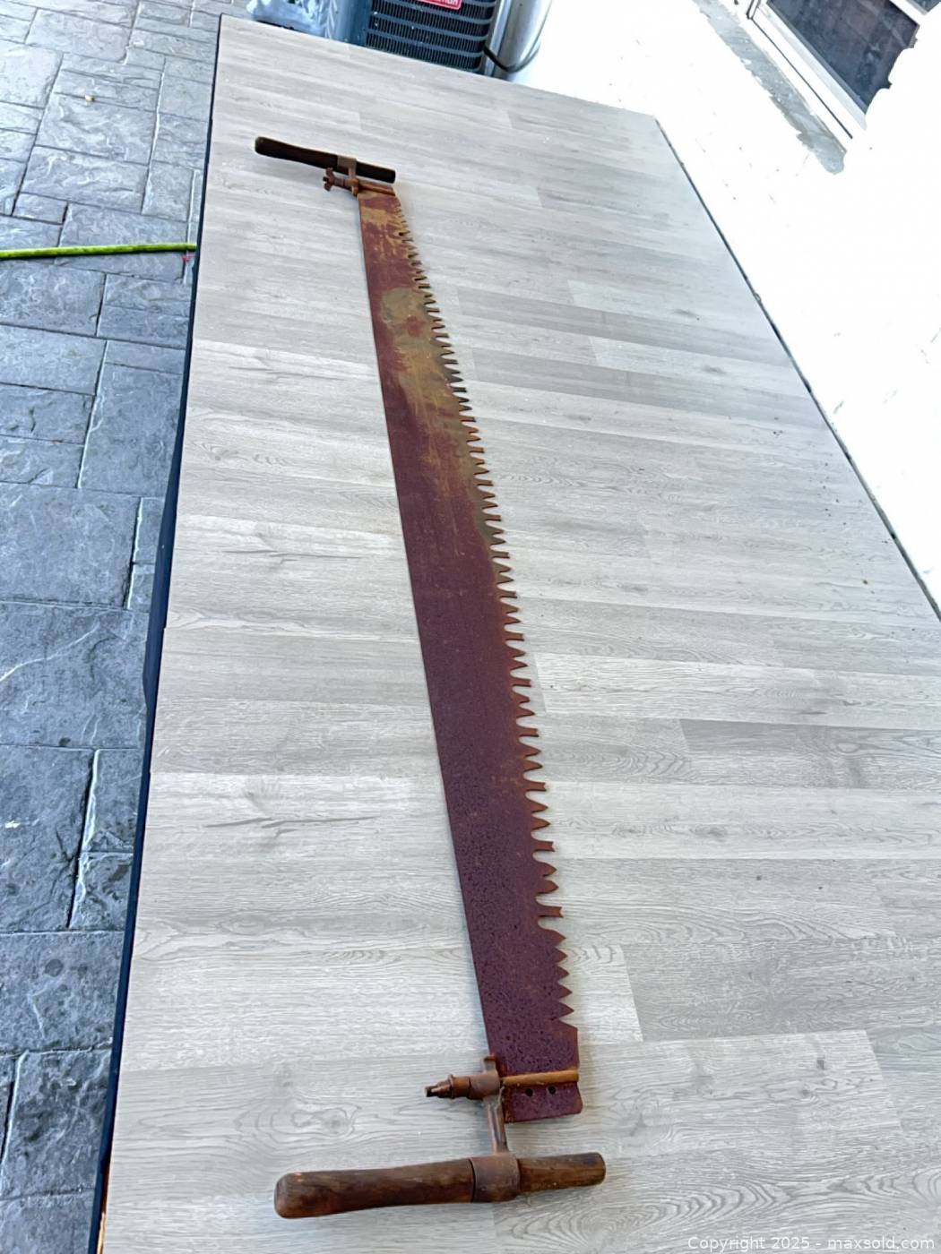 Vintage two-man crosscut logging saw | Maxsold
