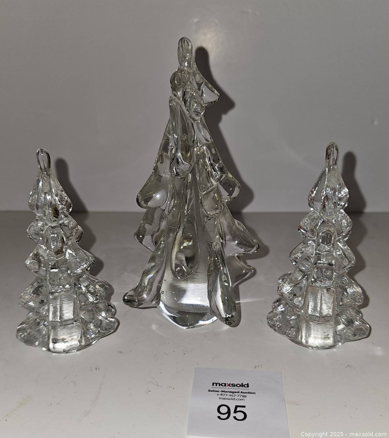 Three clear art glass Christmas tree figures | Maxsold