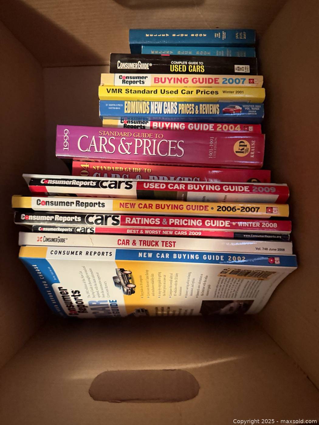 Box of car buying and price guide books | Maxsold