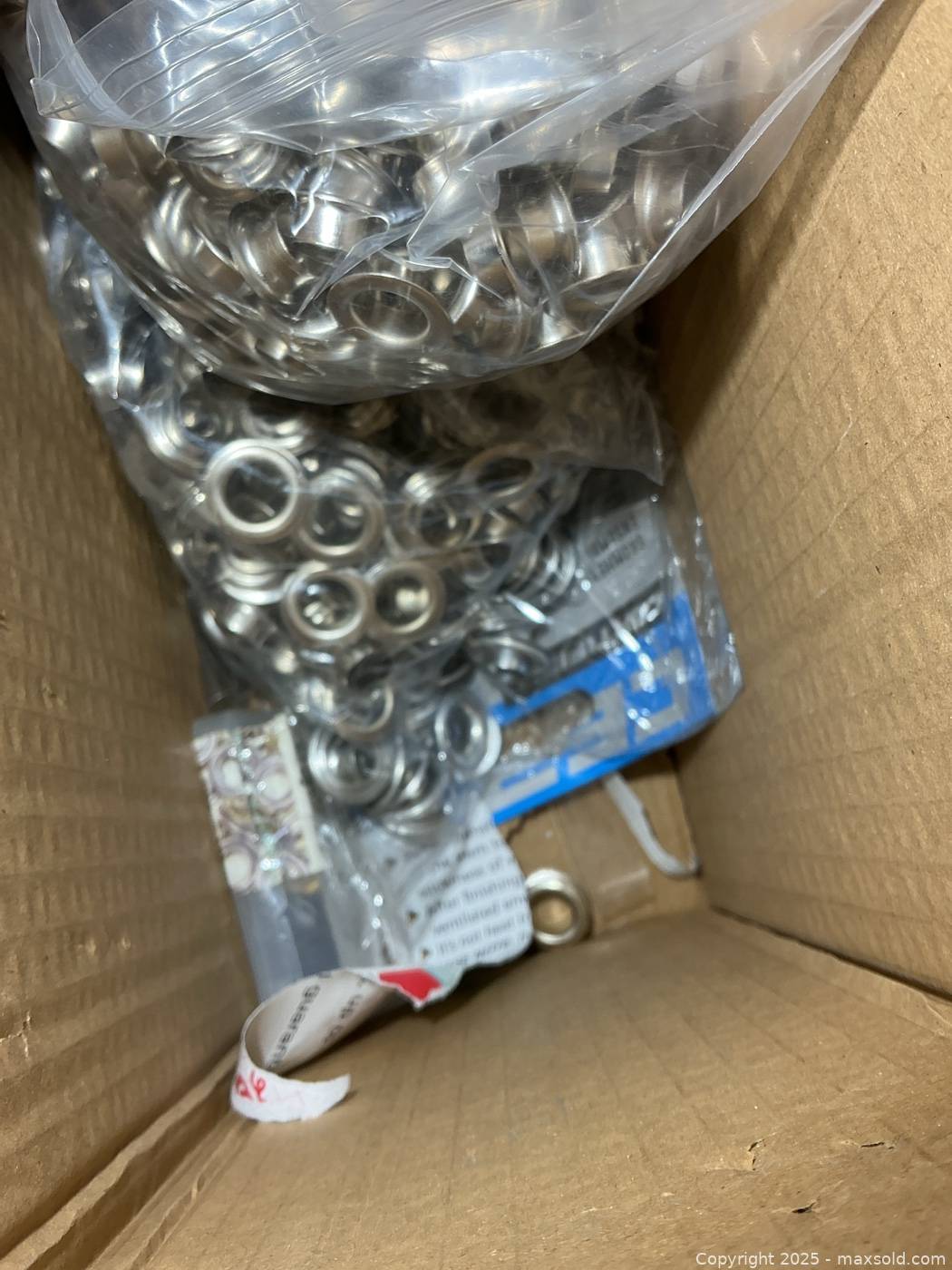 Box of metal grommets with setting tools | Maxsold