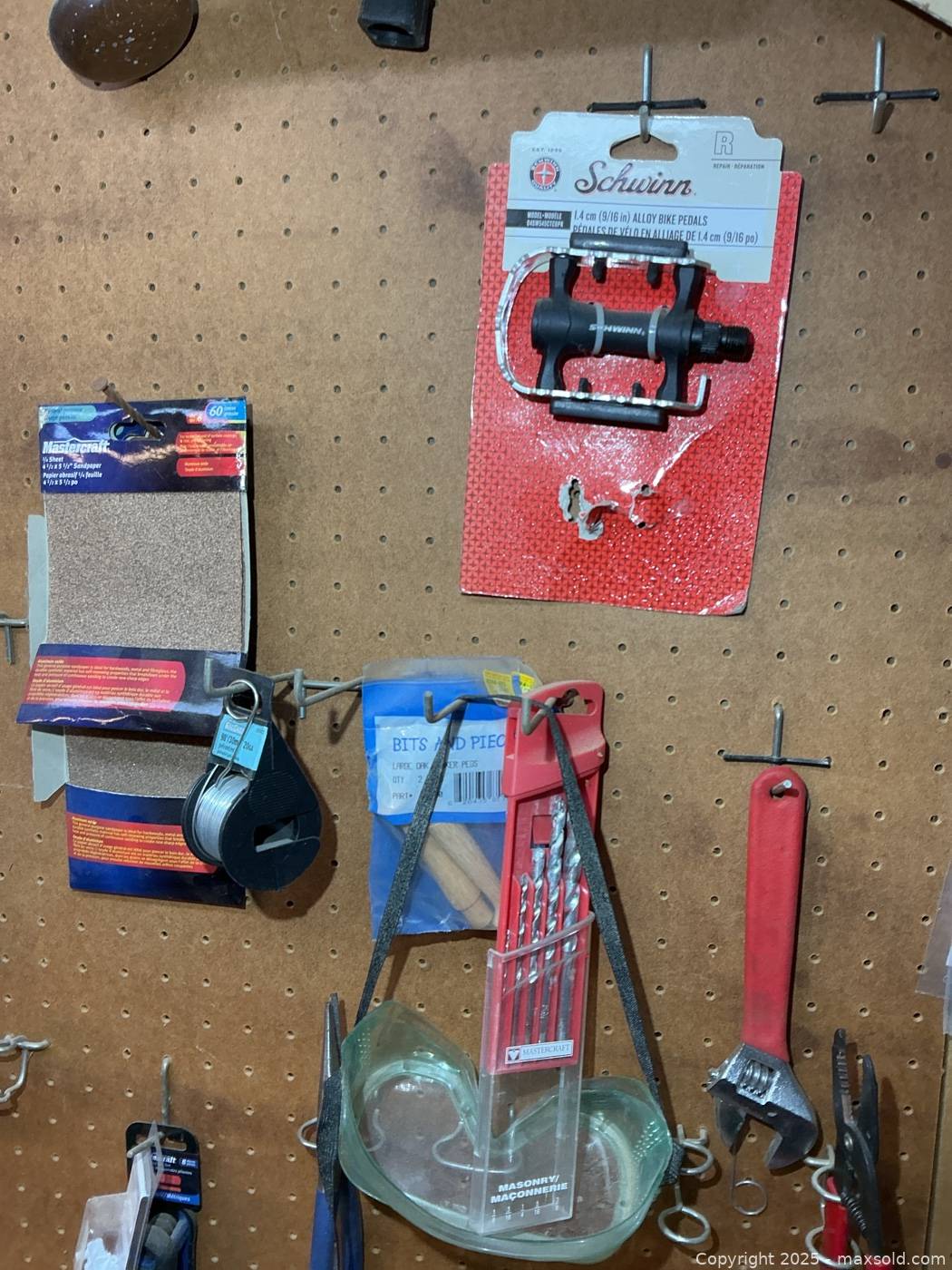 Wall-mounted assortment of hand tools and bits | Maxsold