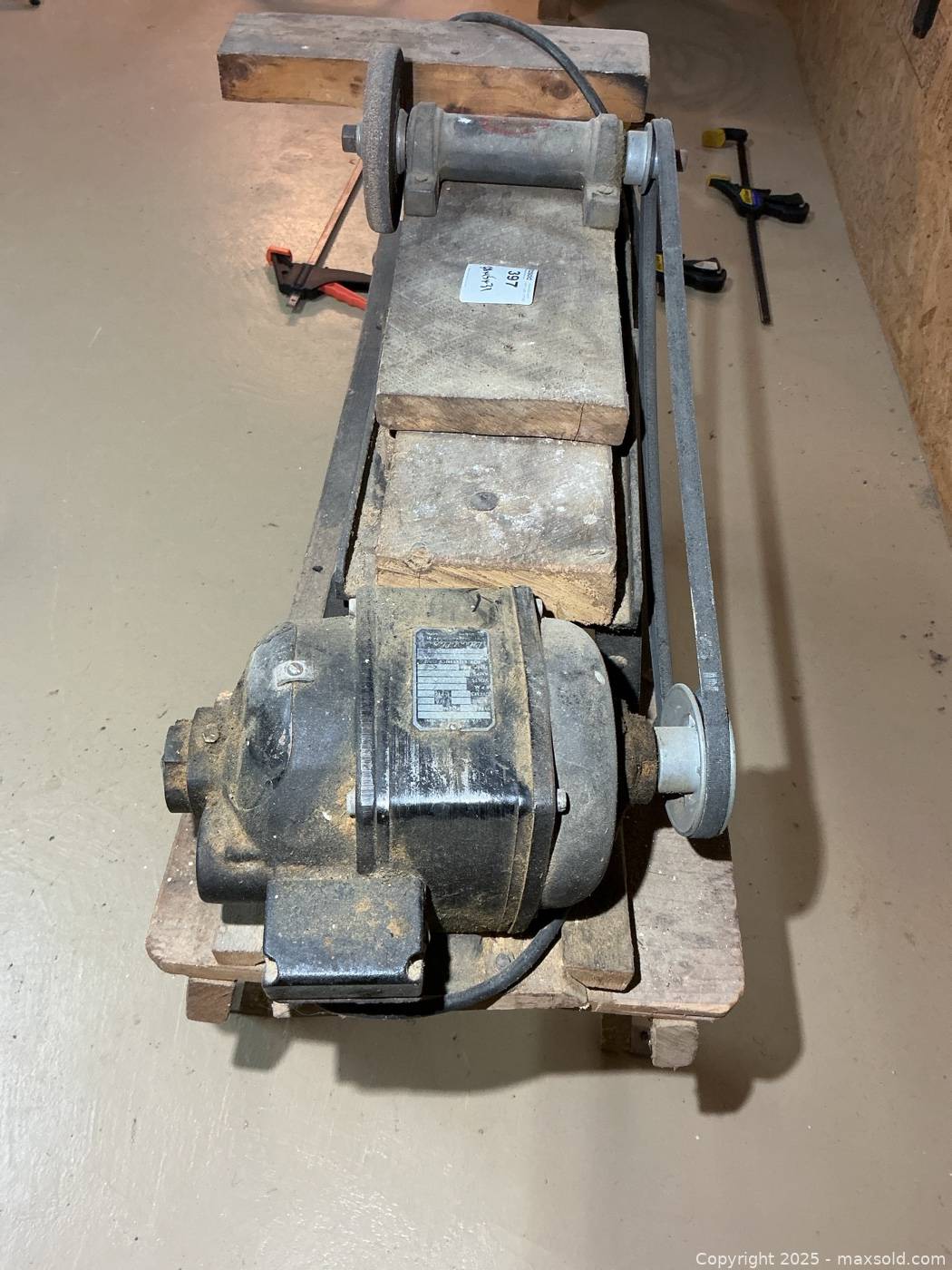 Vintage belt-driven bench grinder on stand | Maxsold