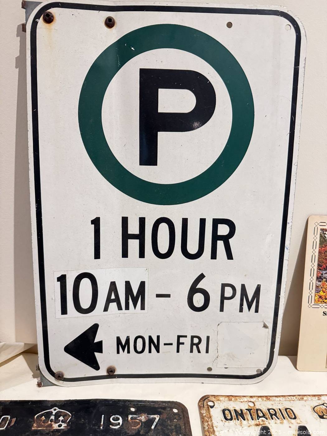 Vintage metal parking sign and license plates | Maxsold