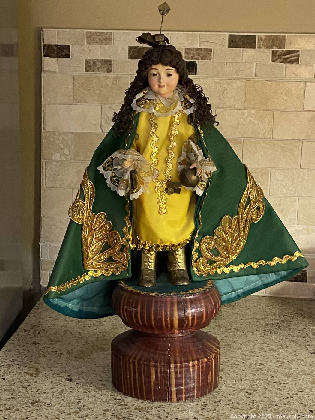 Dressed Niño Dios devotional statue on pedestal | Maxsold