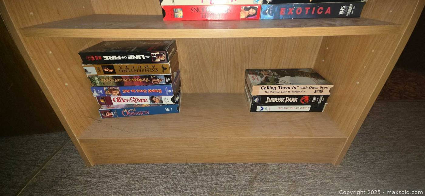 3-shelf laminate bookcase with VHS tapes | Maxsold